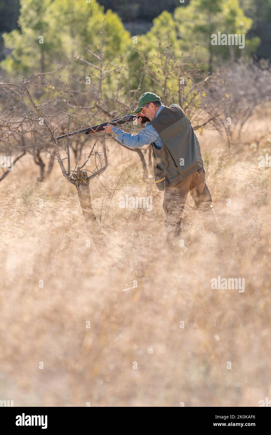 Hunter holding rifle looking away hi-res stock photography and images ...