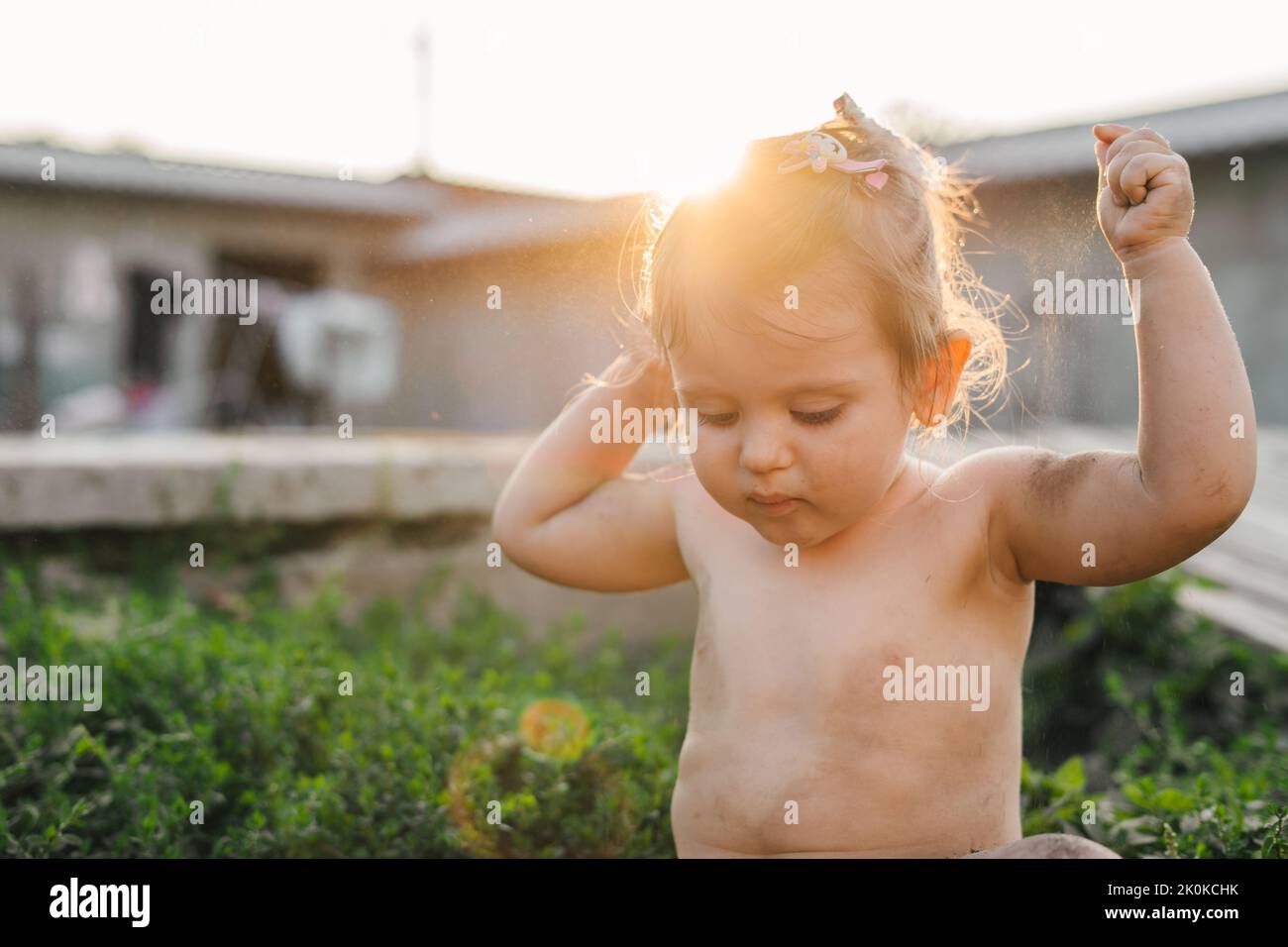 Portrait of adorable baby playing in the garden exploring the world and ...
