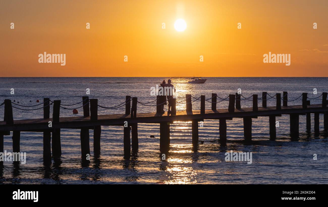 Sunset in Cozumel with a pier and the ocean Stock Photo - Alamy