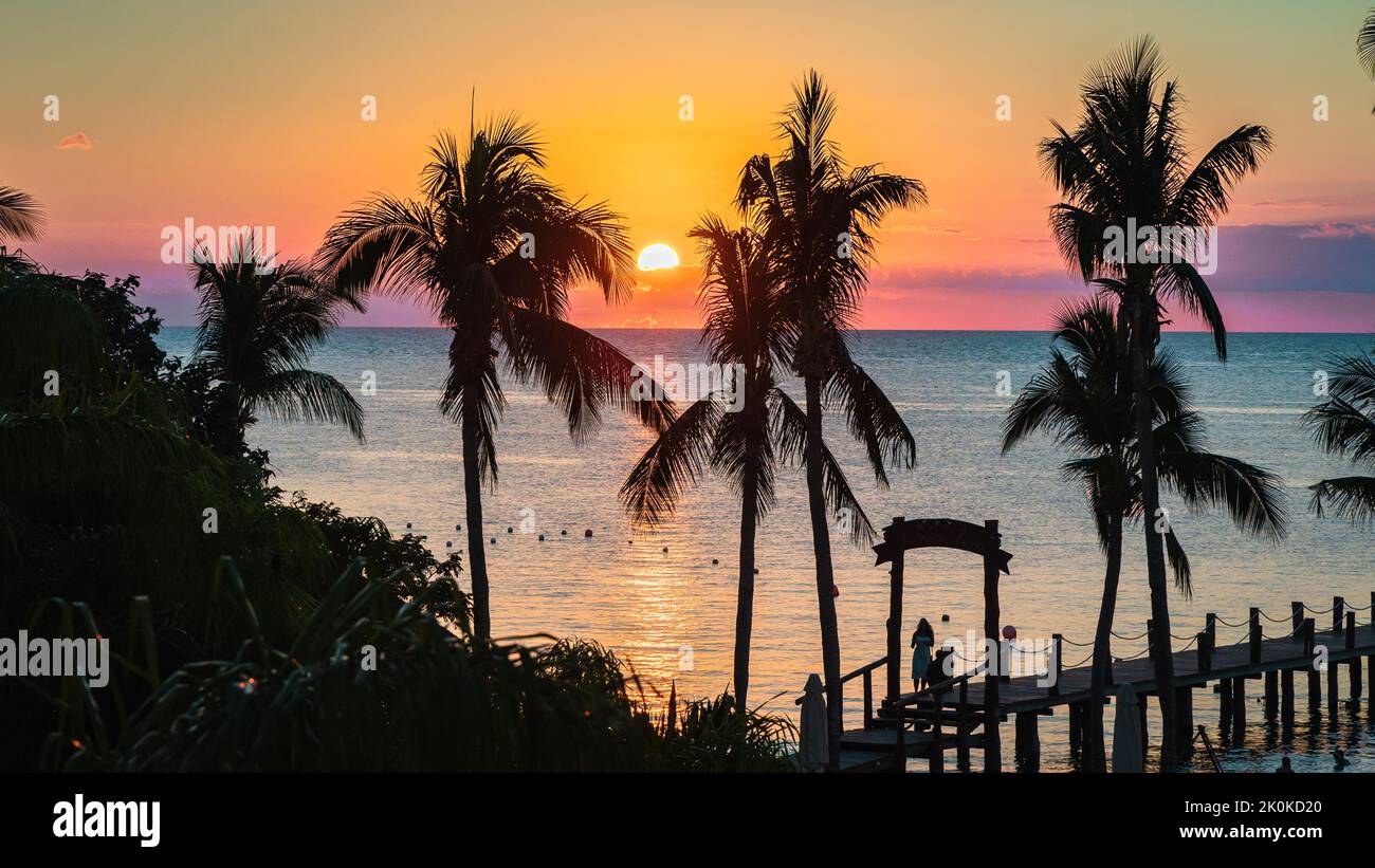 A vibrant sunset over a beach in Cozumel Mexico Stock Photo - Alamy