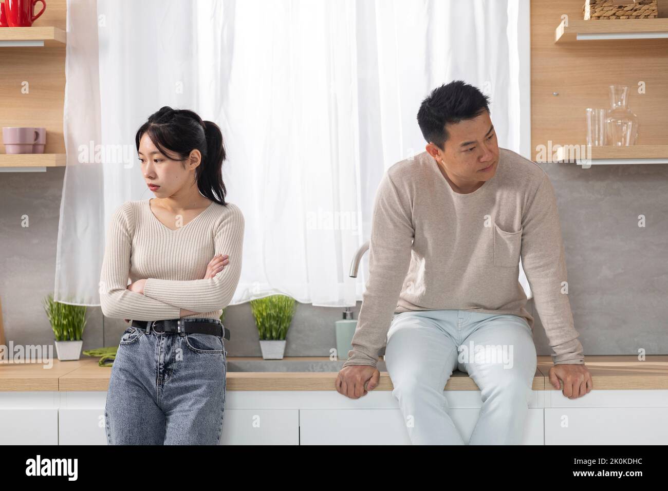 Upset chinese man and woman having quarrel at kitchen Stock Photo - Alamy