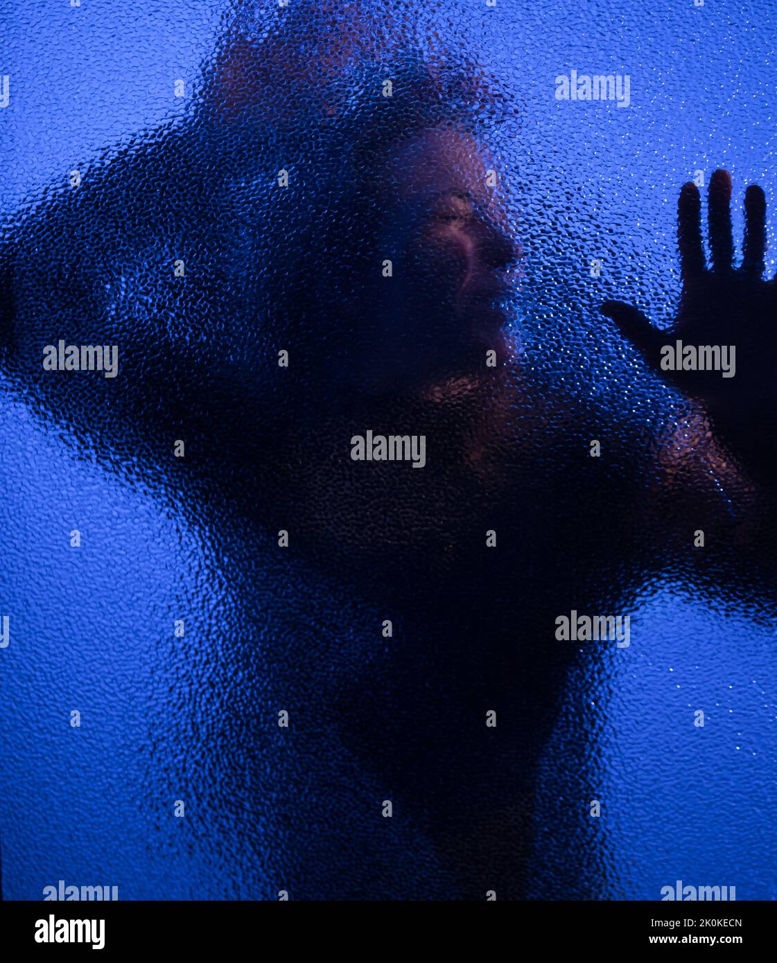 Shadow of woman screaming behind the glass, domestic violence concept ...