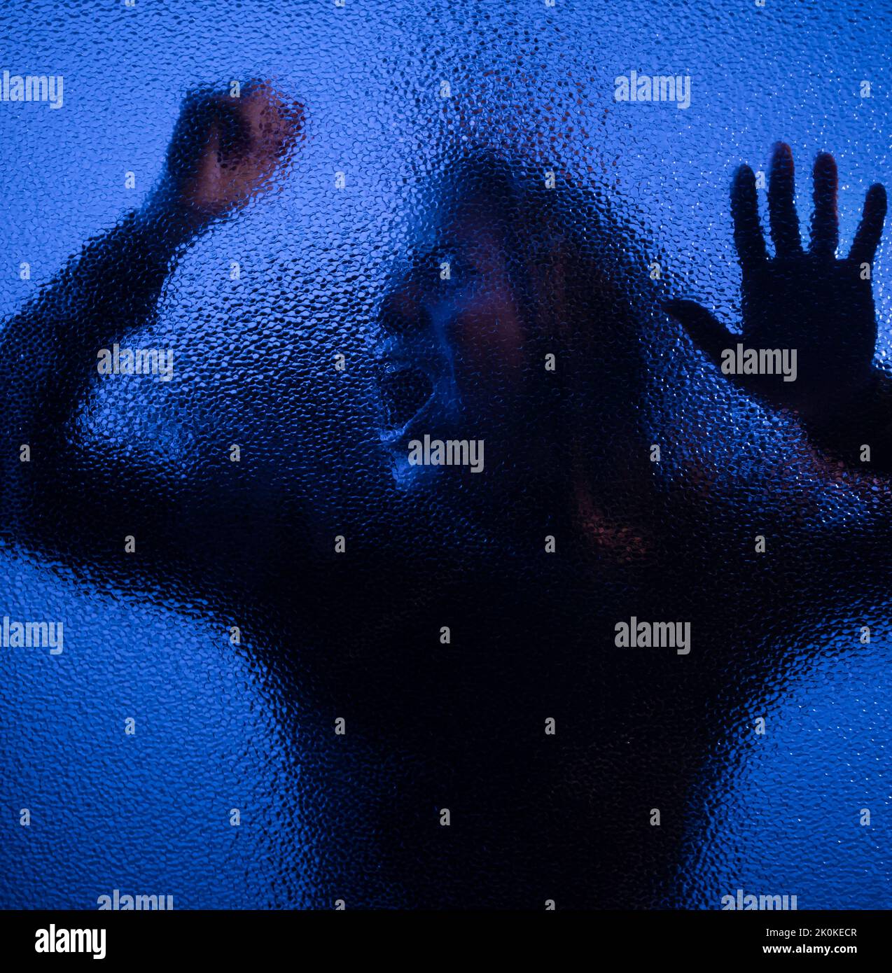 Shadow of woman screaming behind the glass, domestic violence concept ...