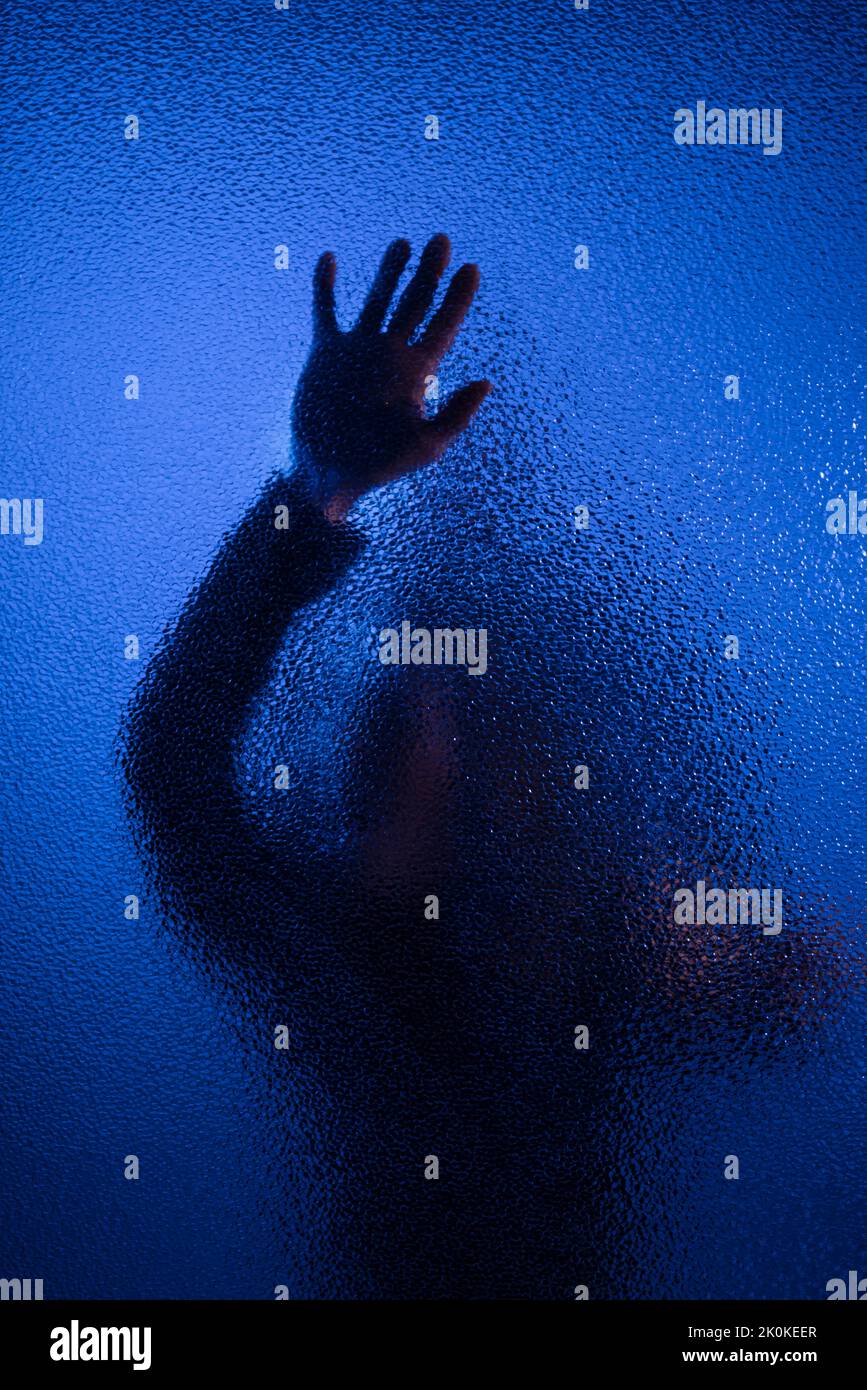 Shadow of woman screaming behind the glass, domestic violence concept ...