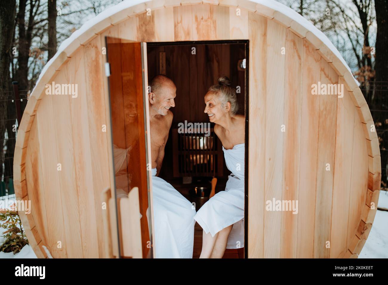 Senior couple enjoying together time in wooden sauna, relax, spa and ...