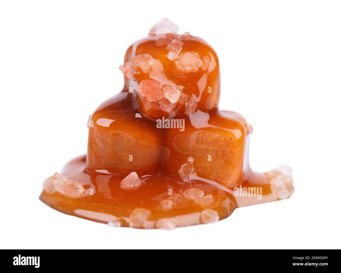 Sweet caramel candies and sauce, isolated on white background ...