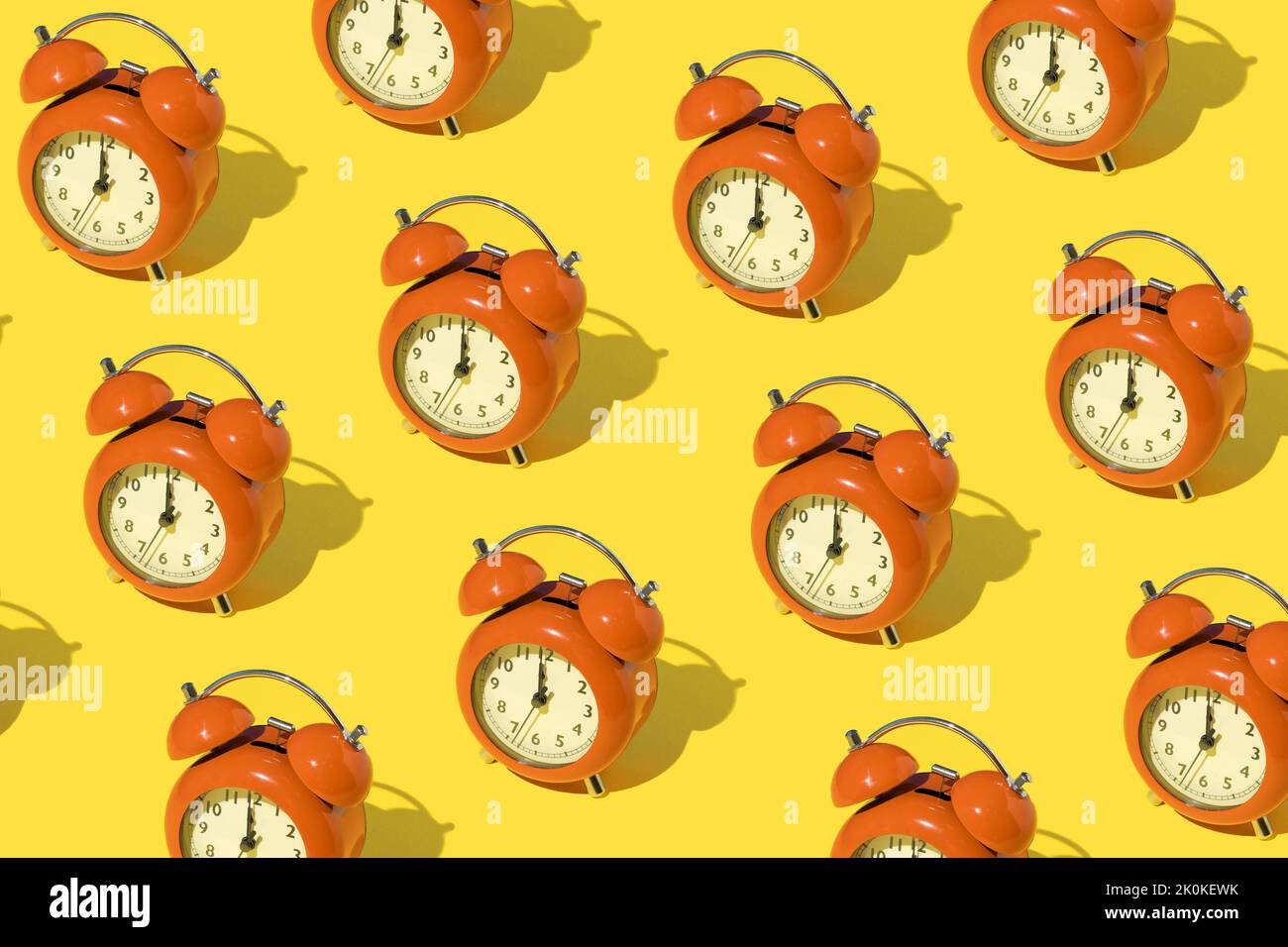 Pattern made of red retro clocks on yellow background Stock Photo - Alamy