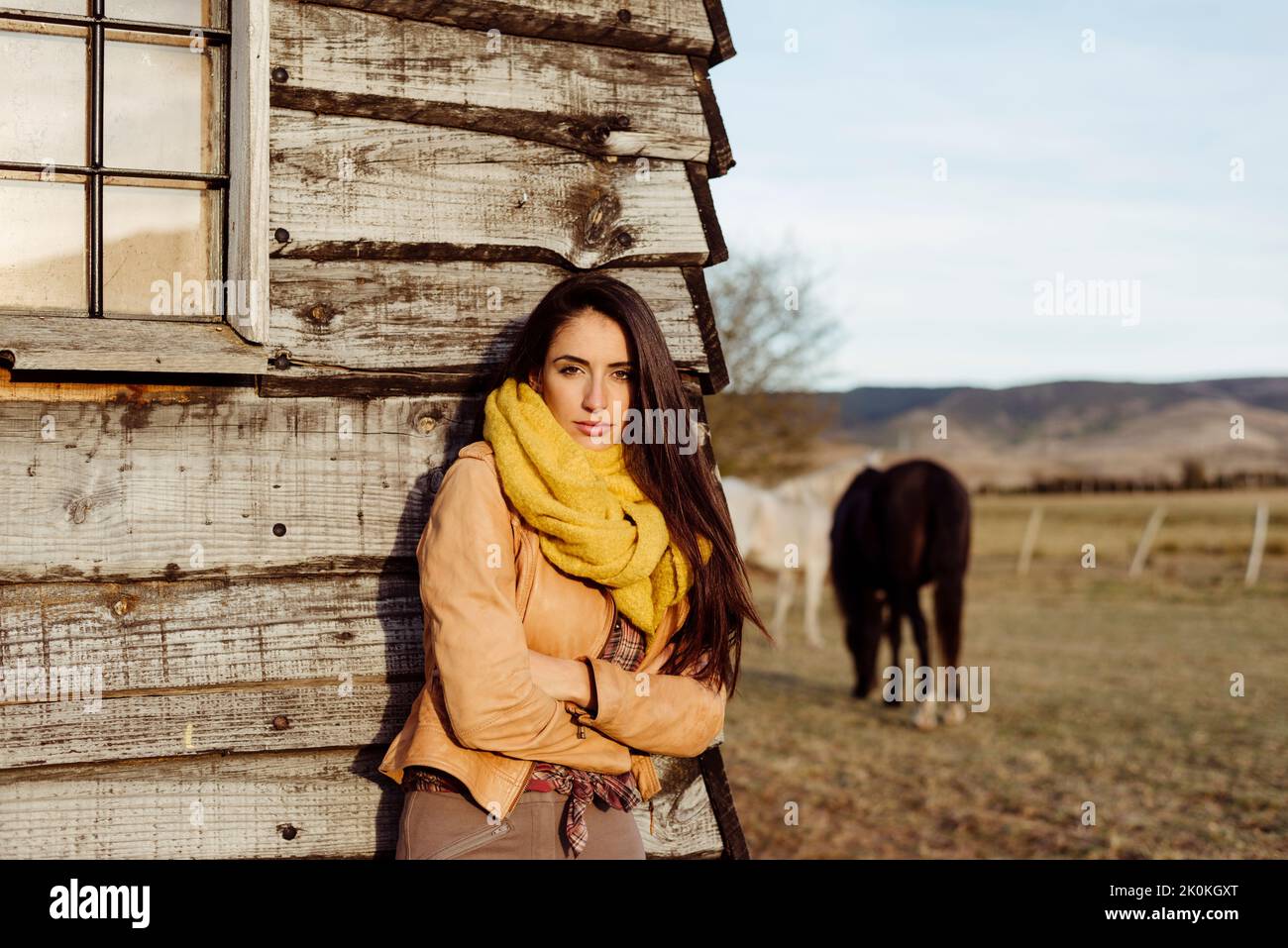 Stylish woman on ranch standing in a wooden cabin Stock Photo - Alamy