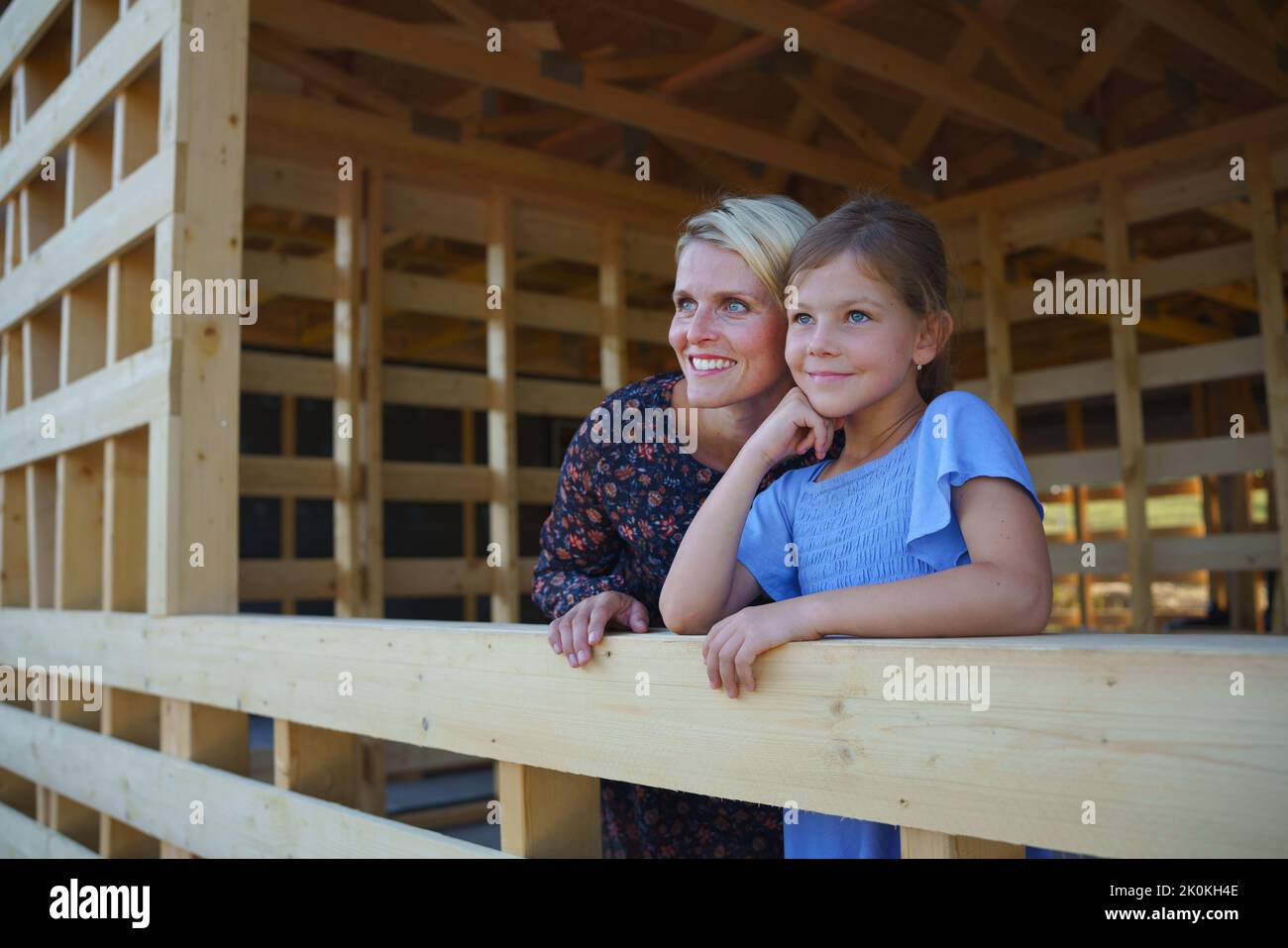 Mother and daughterr on site inside new ecology wooden home ...