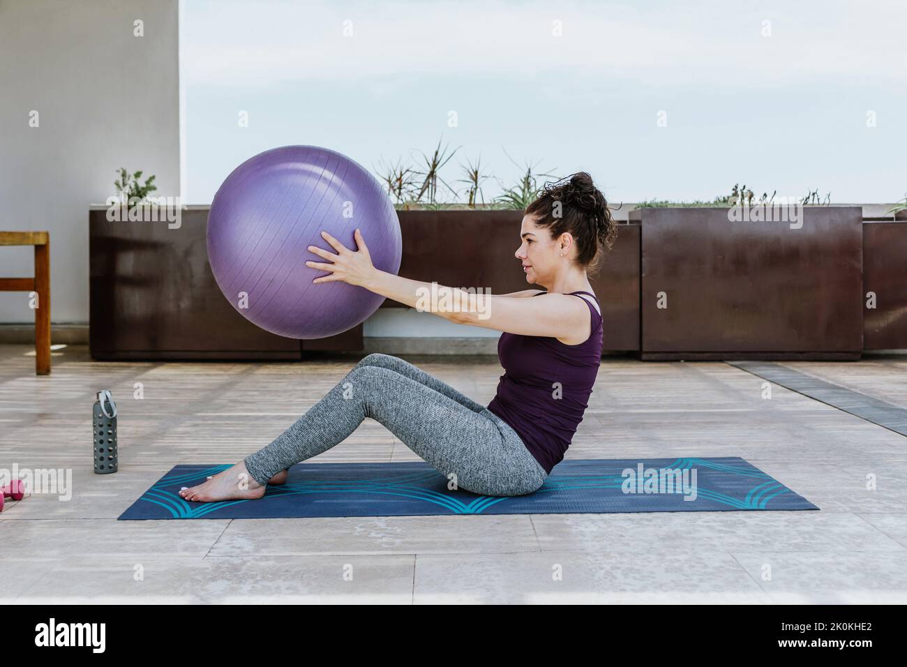 Full body of concentrated fit young female athlete in activewear doing ...