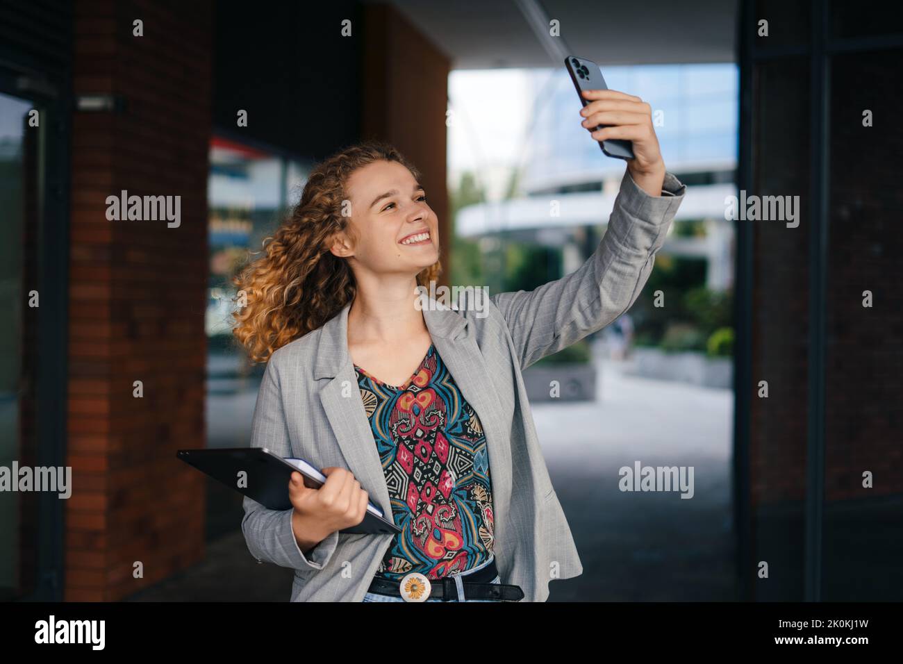 Beautiful happy young caucasian woman student taking a selfie photo ...