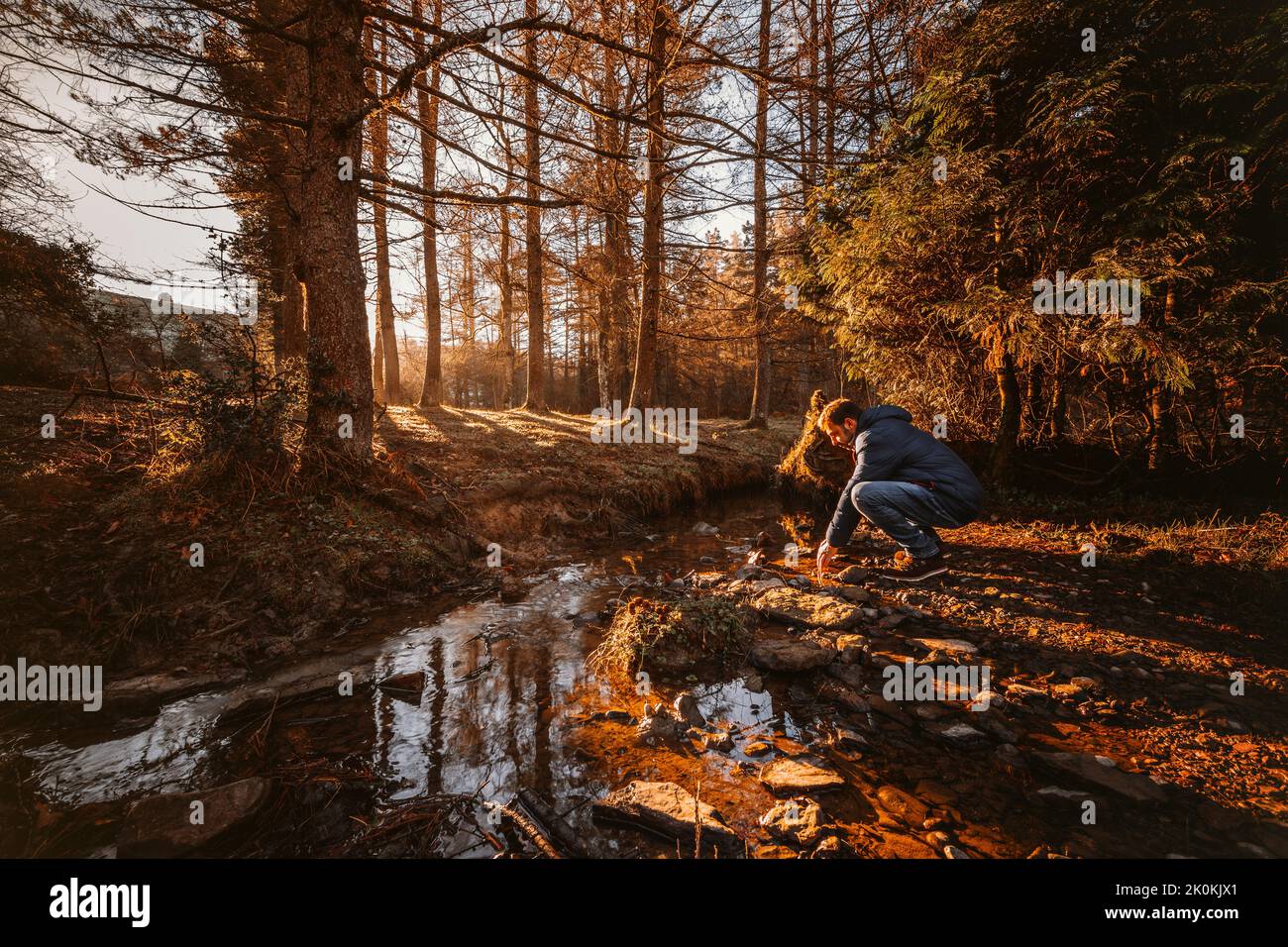 Traveler washing his hands in a river Stock Photo - Alamy