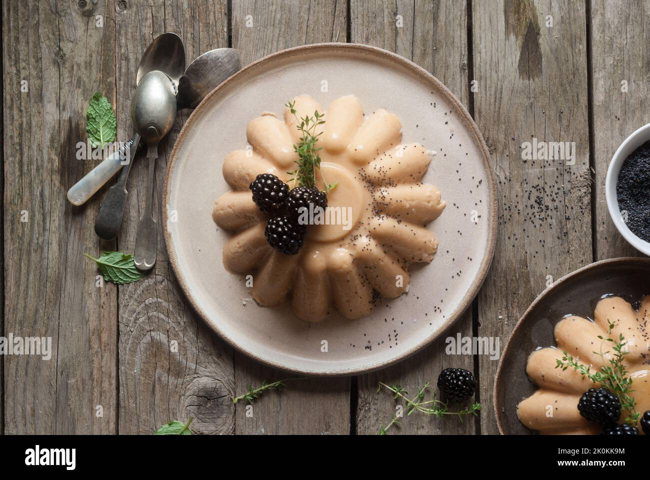 Flat lay of arranged served panna cotta with peach and poppy seeds on ...