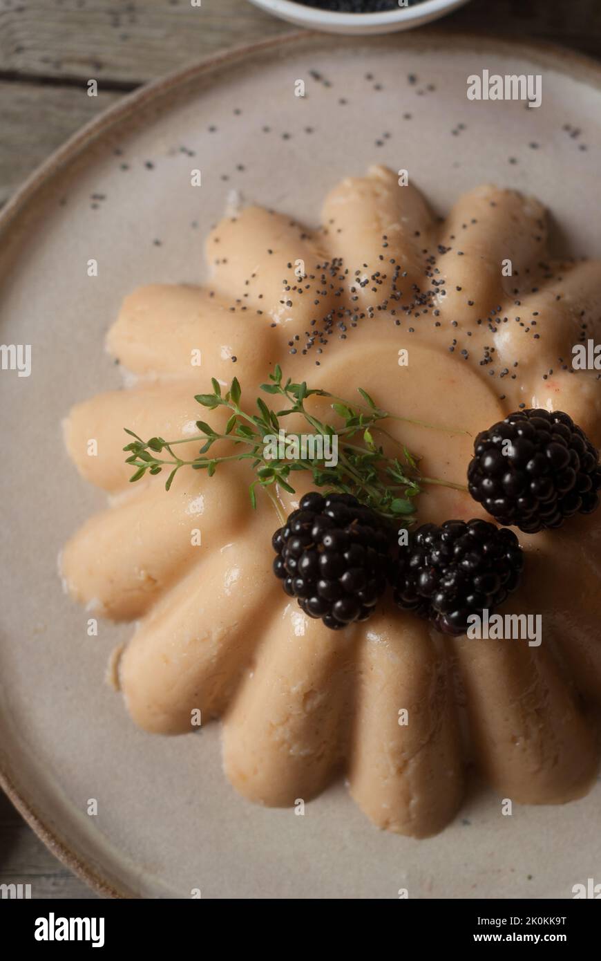 Closeup from above shot of tender peach panna cotta with blackberry and ...