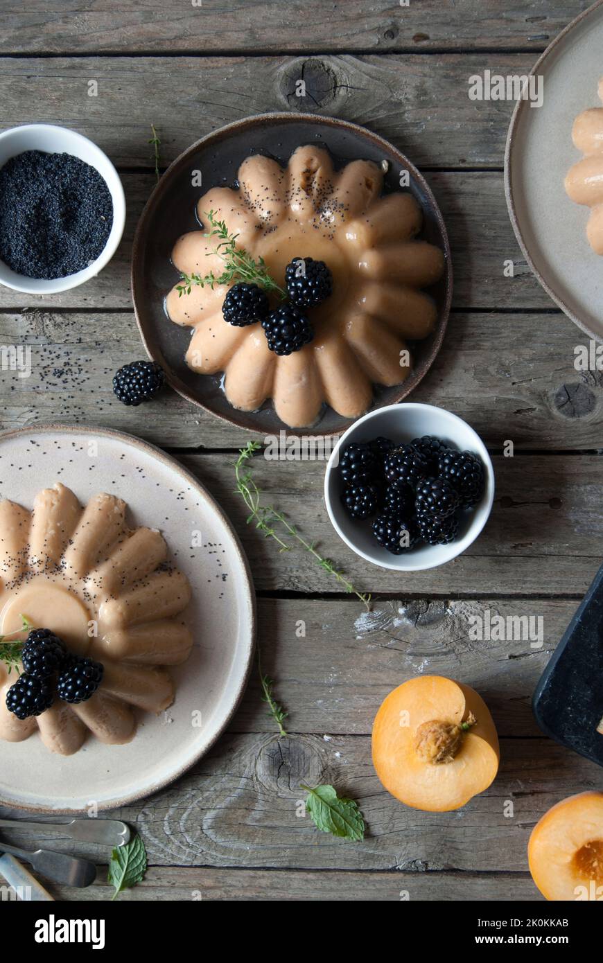 Flat lay of arranged served panna cotta with peach and poppy seeds on ...