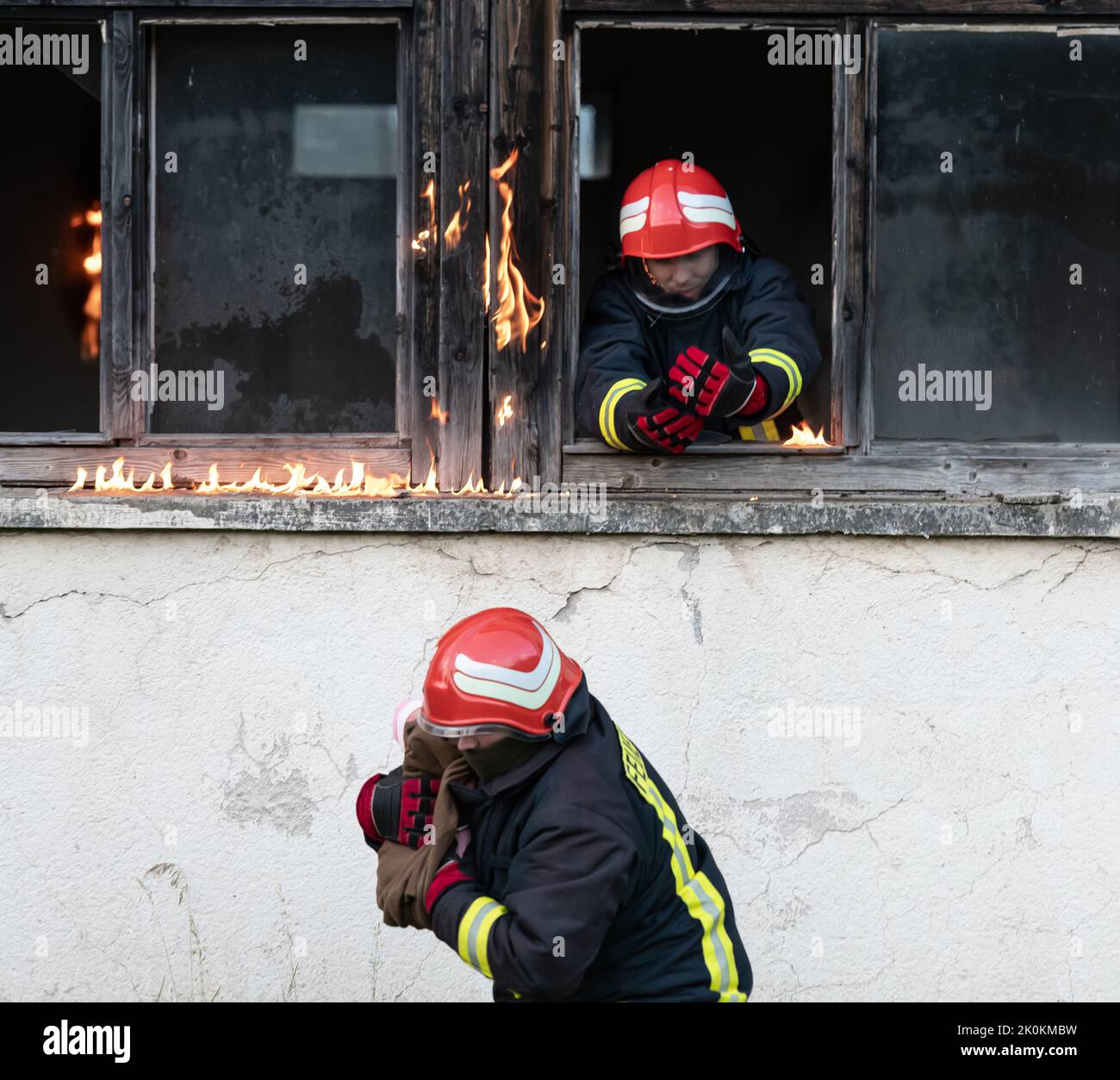 Firefighter hero carrying baby girl out from burning building area from ...