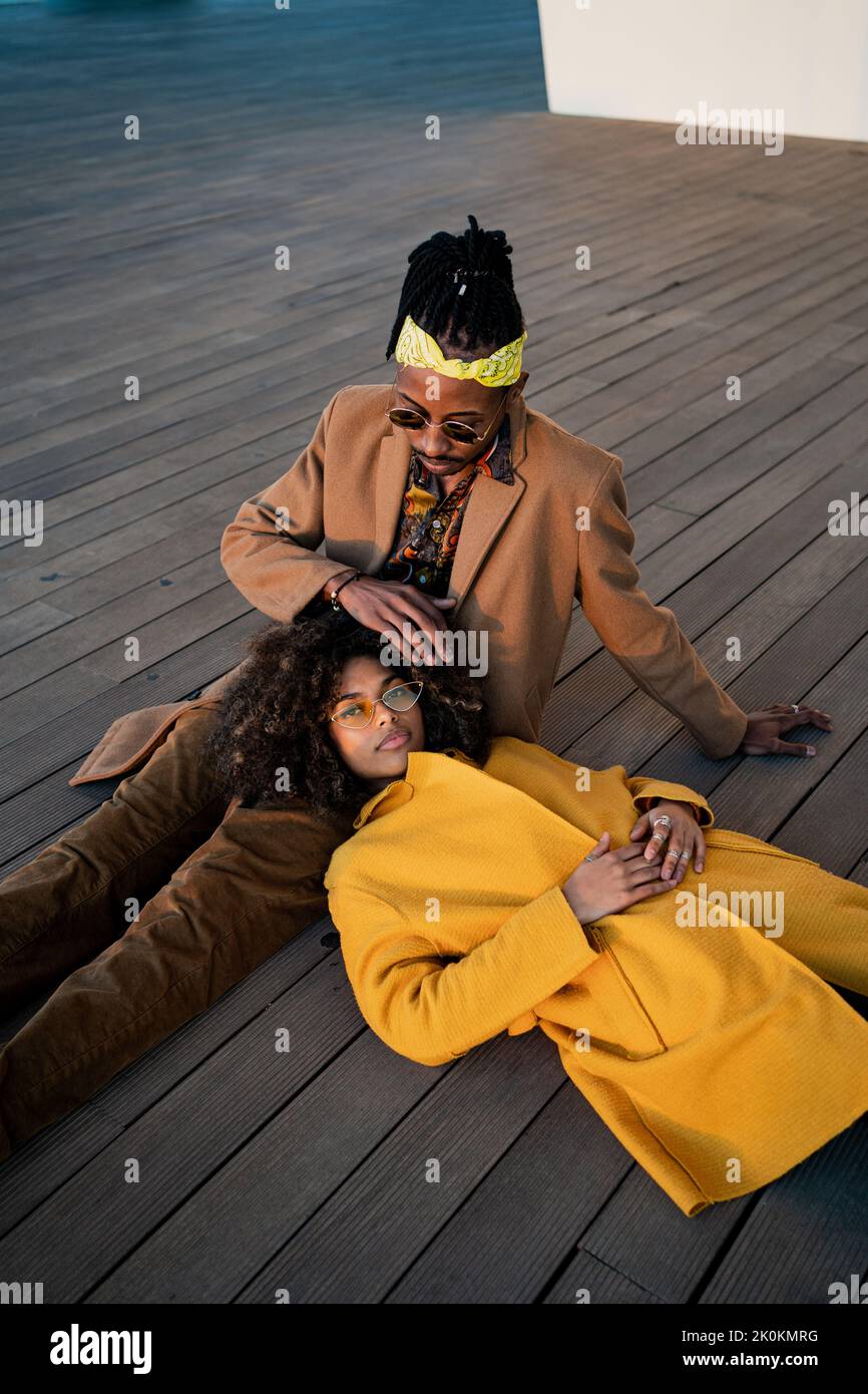 Loving black man with dreadlocks caressing hair of charming girlfriend ...