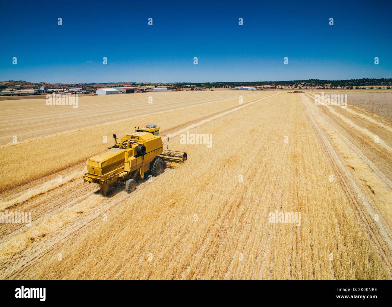 Aerial view of powerful fast yellow vehicle working on field ...