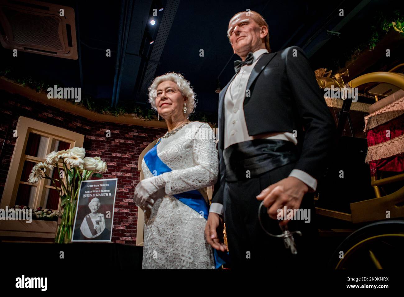 Wax figures honoring Queen Elizabeth II are on display at the i-City ...