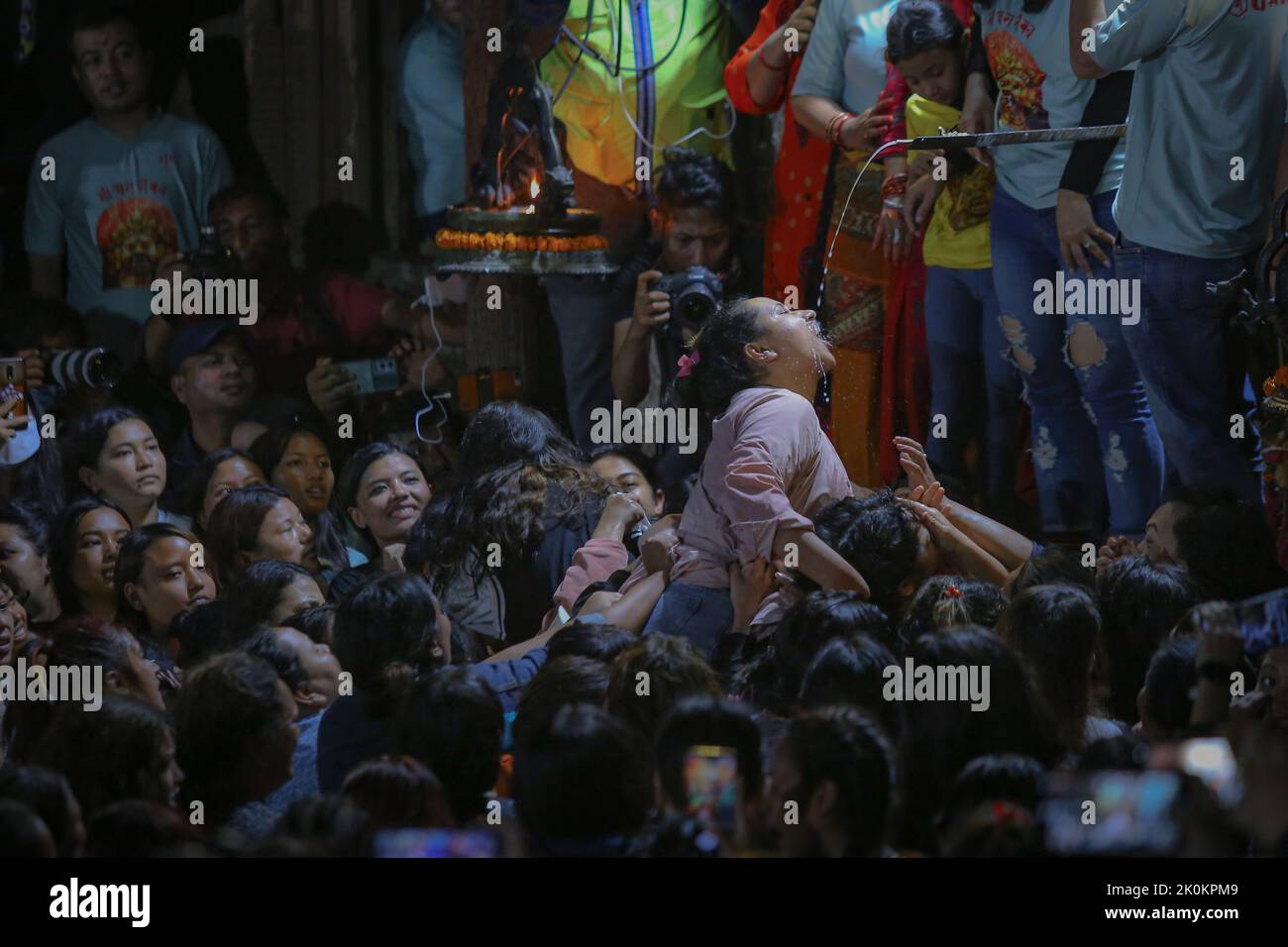 On Sept. 11, 2022 in Kathmandu, Nepal. Women devotees drinks homemade ...