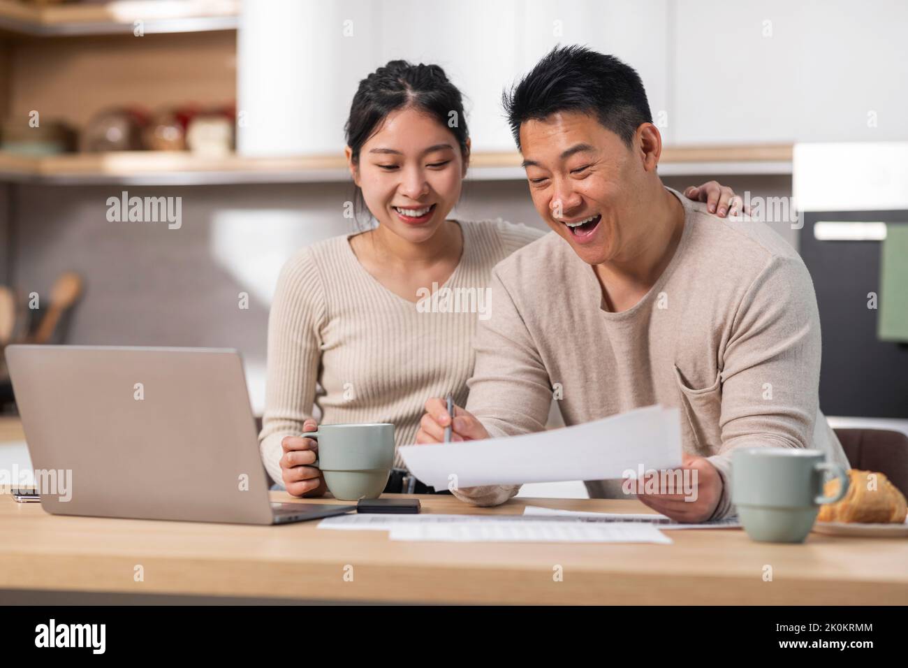 happy asian couple paying bills on Internet, using laptop Stock Photo ...