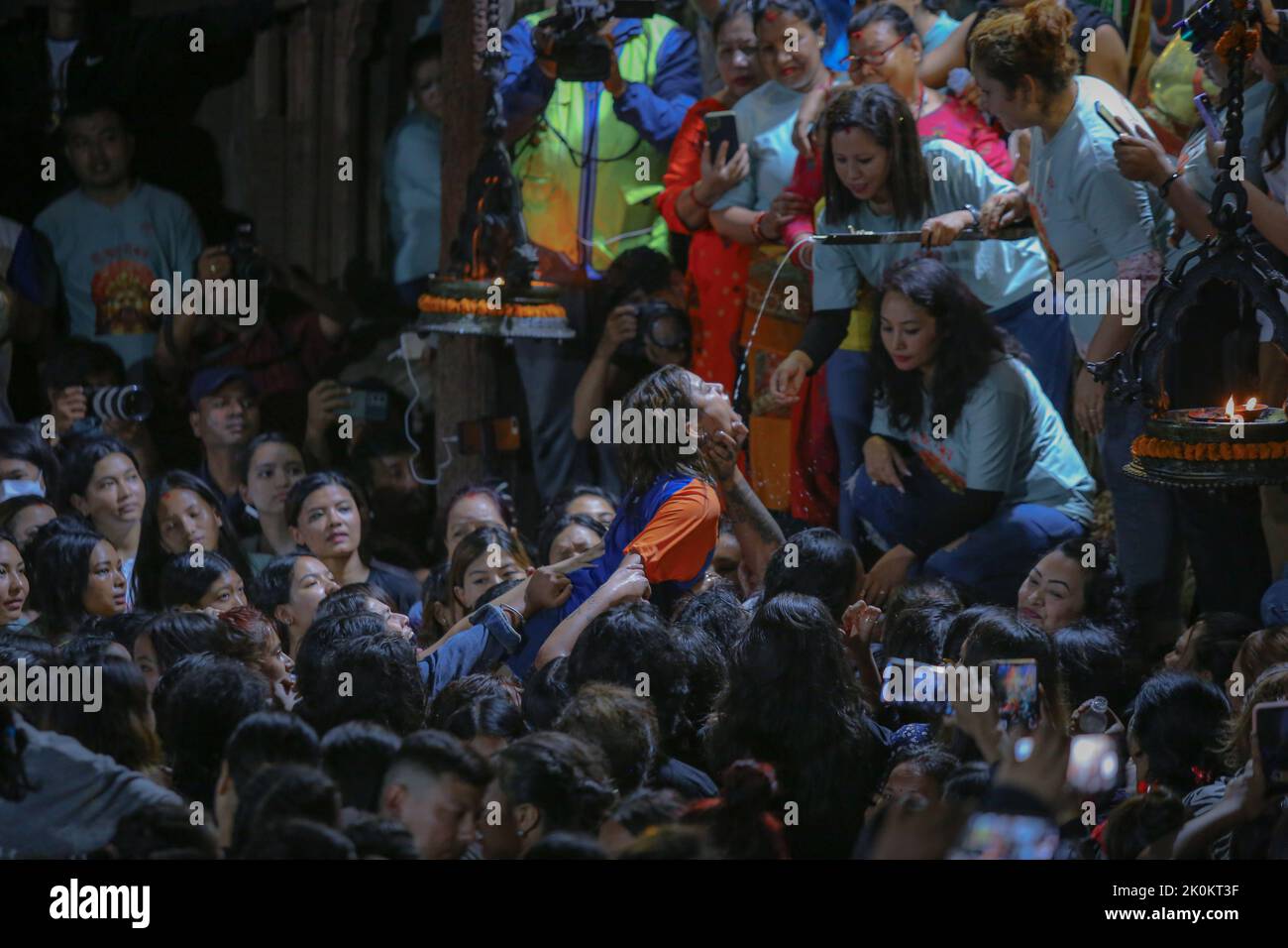 On Sept. 11, 2022 in Kathmandu, Nepal. Women devotees drinks homemade ...