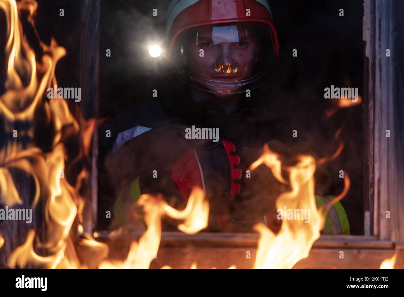 Firefighter hero carrying baby girl out from burning building area from ...