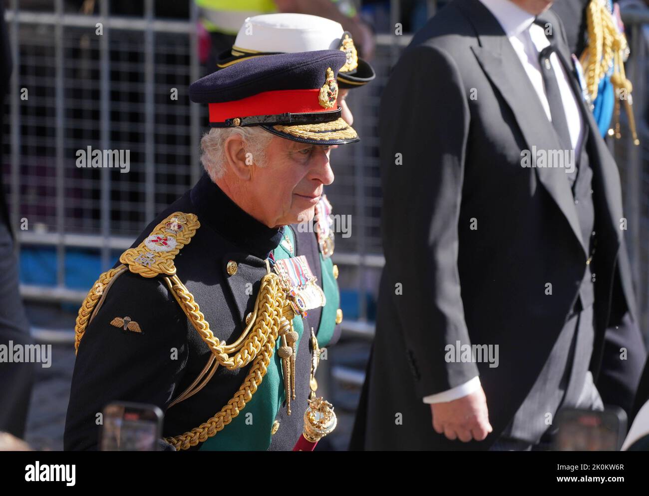 King Charles III walks behind Queen Elizabeth II's coffin during the procession from the Palace ...