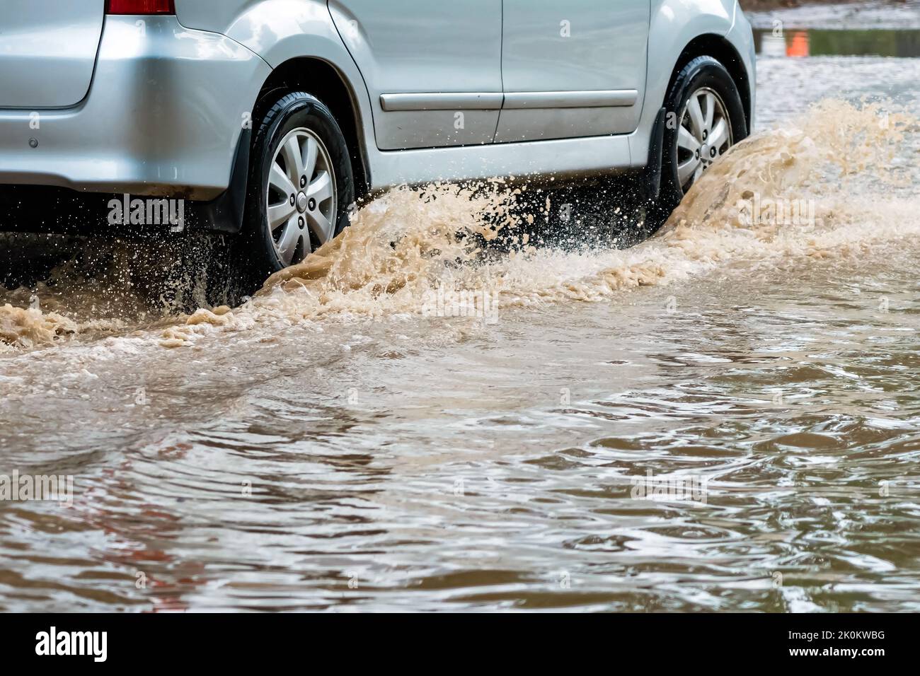 Car passing through a flooded road. Driving car on flooded road during ...