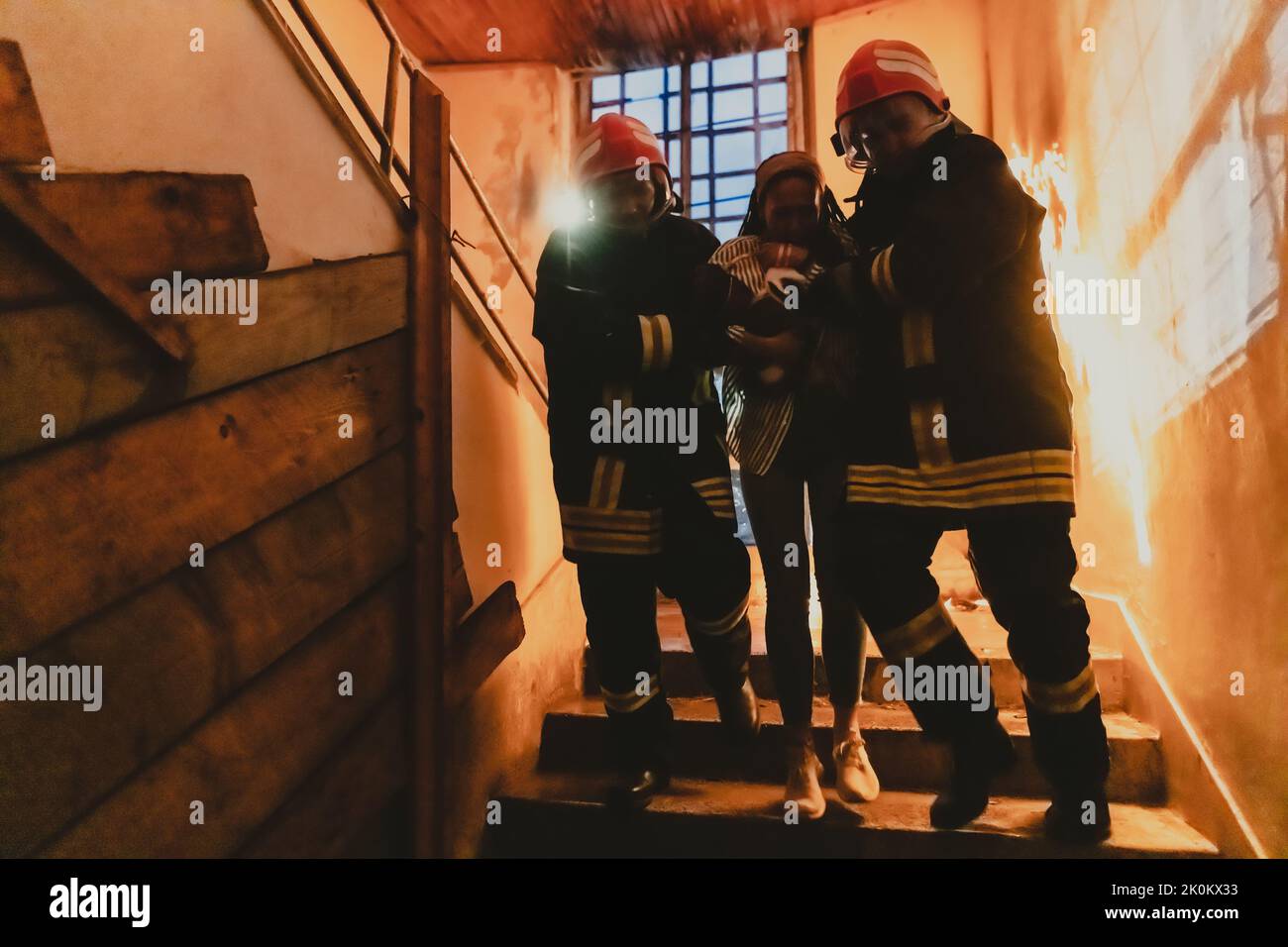 Brave Fireman Descends Stairs of a Burning Building and Holds Saved ...