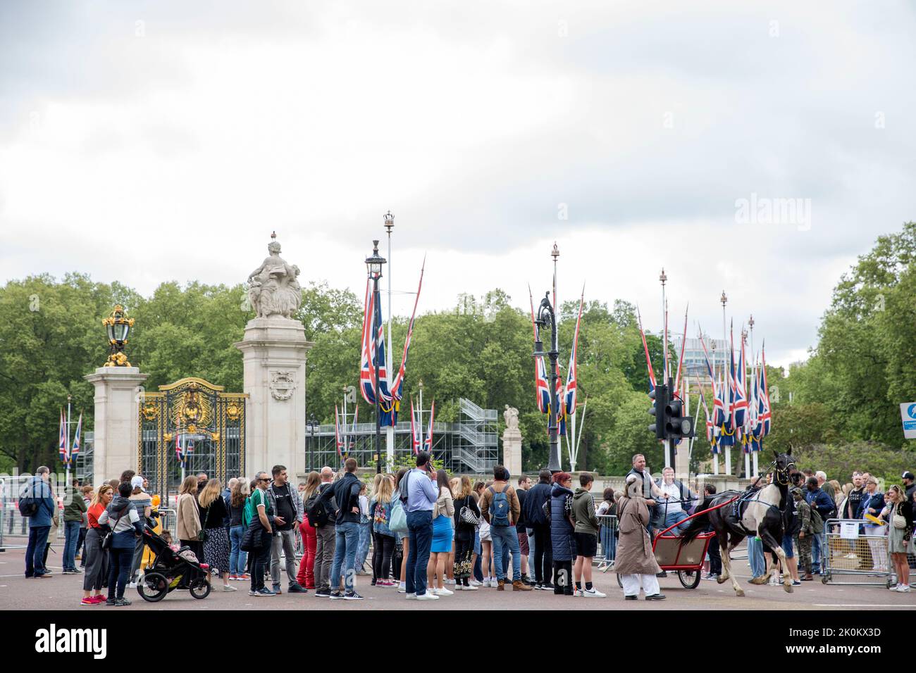 People gather as horse-drawn carriages run around temporary structures ...