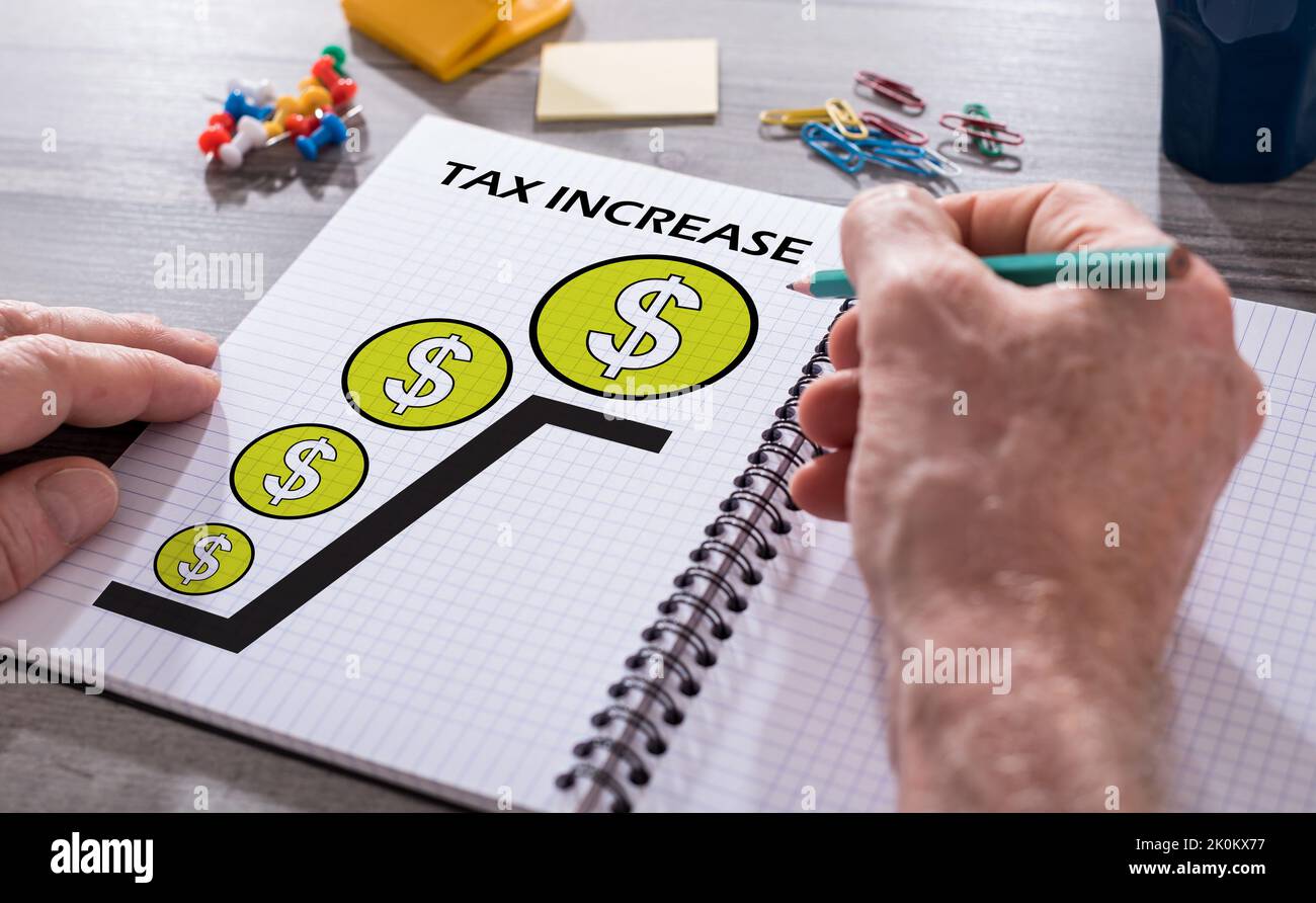 Hand drawing tax increase concept on a notepad Stock Photo - Alamy