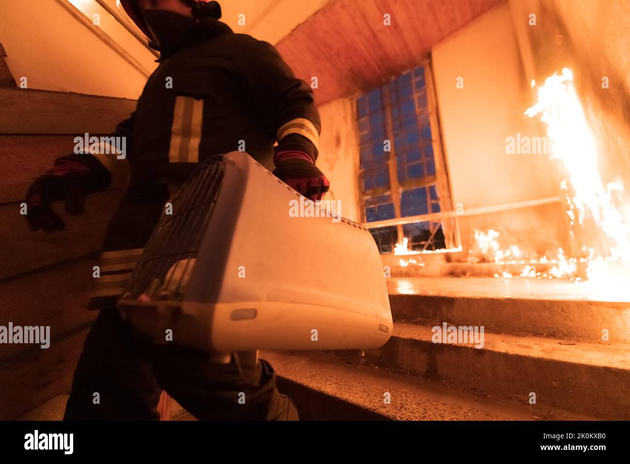 Firefighter hero carrying cat pet animal in carrying bag box out from ...