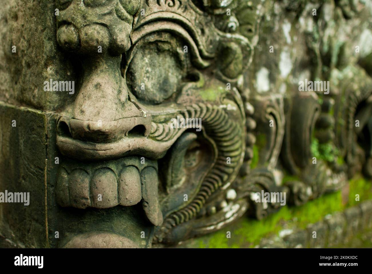 Balinese carvings, made of natural stone, overgrown with moss Stock ...