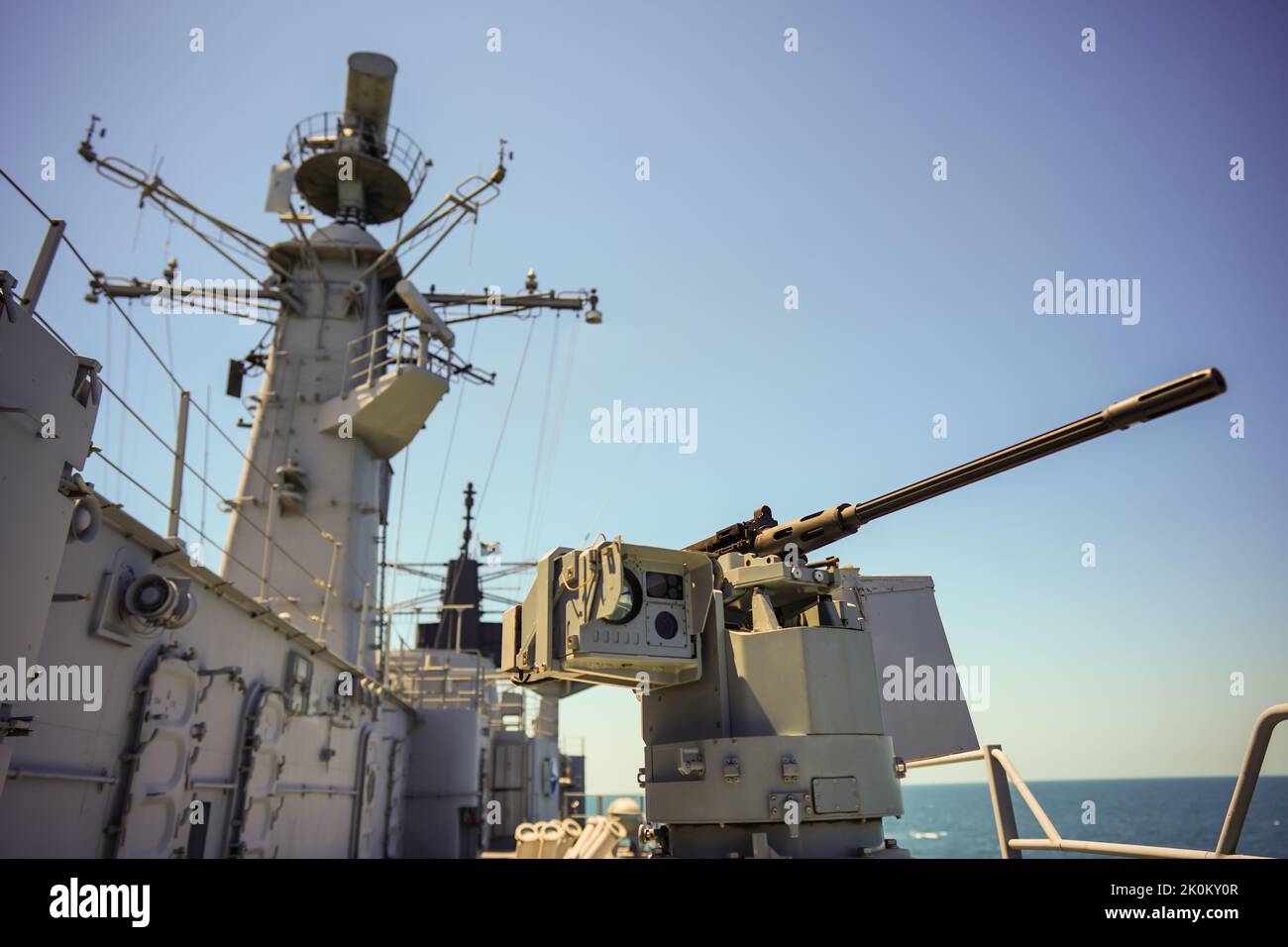 Color image of an automated machine gun on the deck of a military ship ...