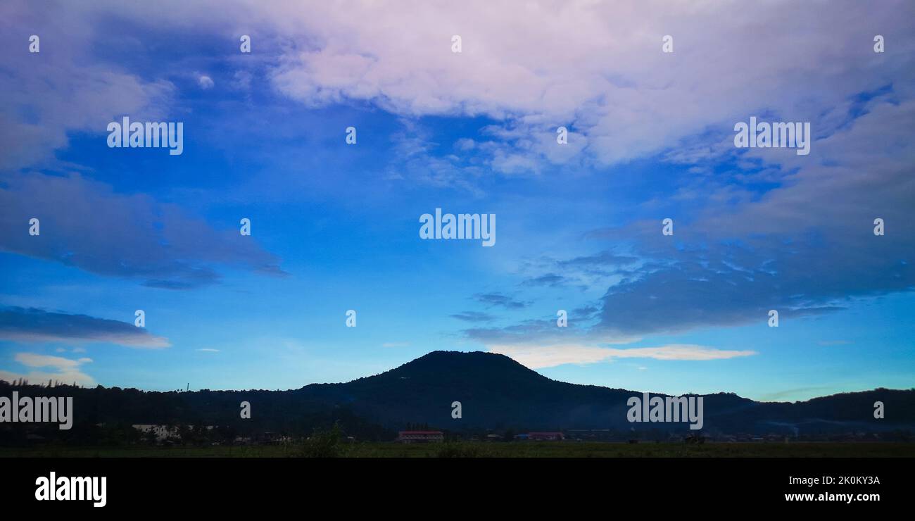A beautiful shot of a distant mountain under blue cloudy sky Stock ...