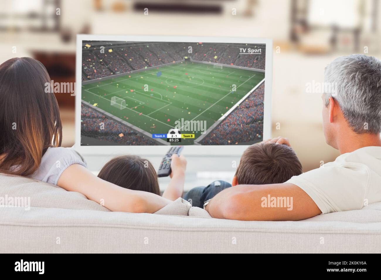 Caucasian family sitting on the couch and watching football match Stock ...