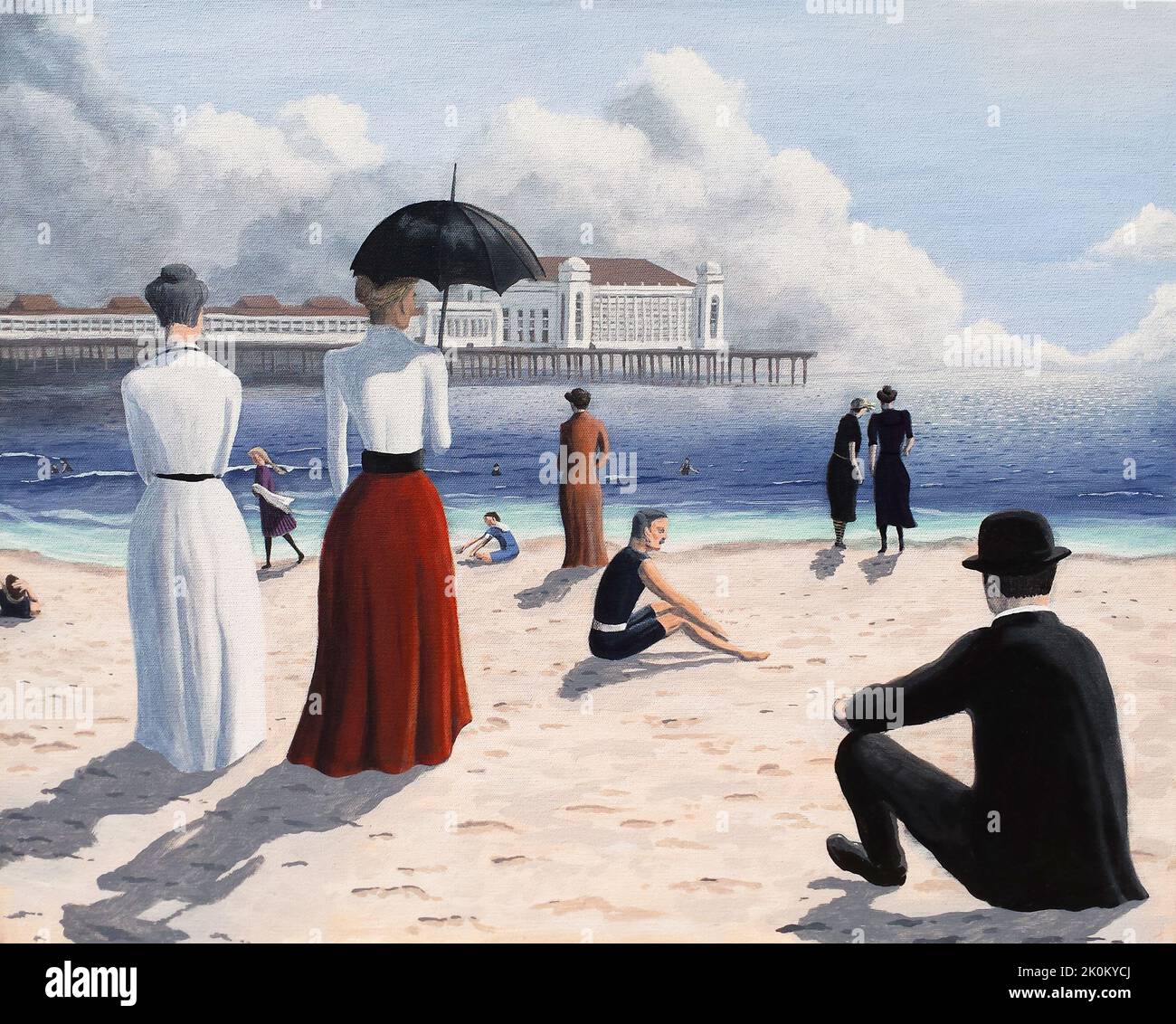 1900s era scene of people gathered on the beach, some swimming, and the ...