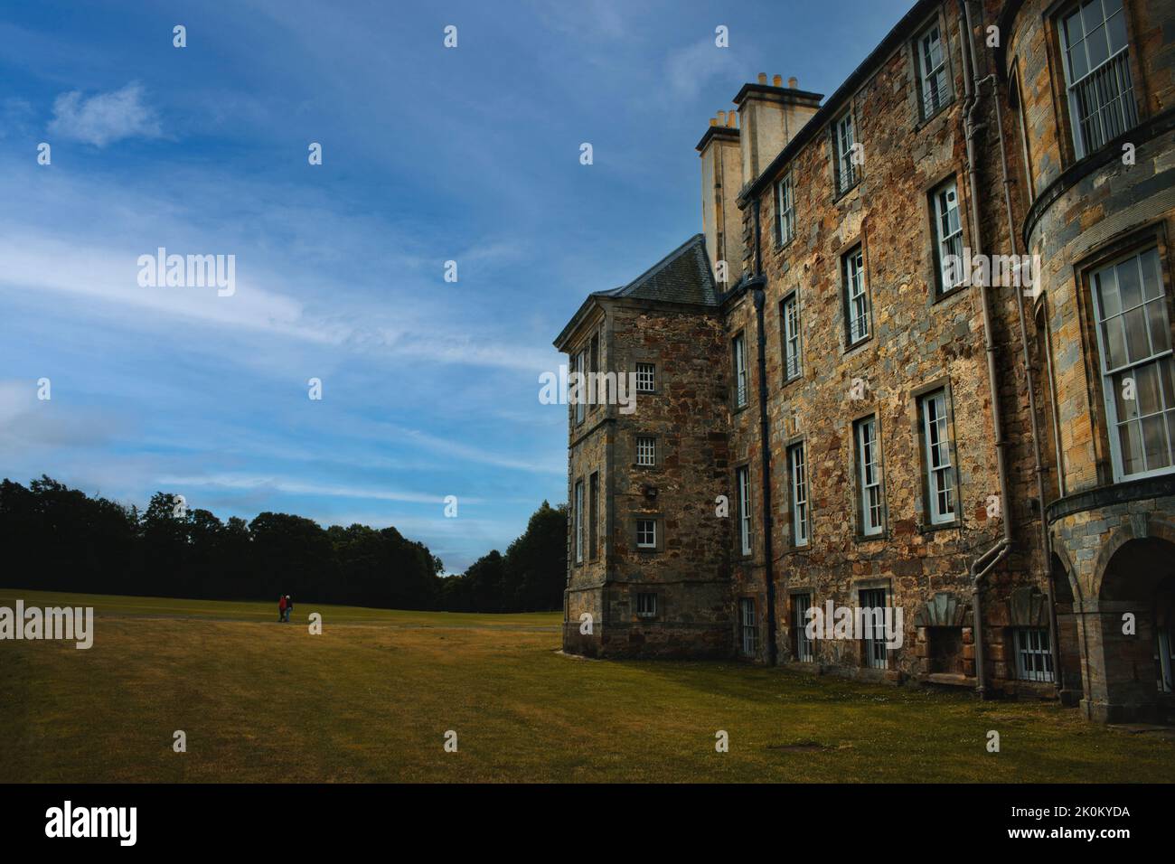 The side facade of the historical Dalkeith Palace under blue cloudy sky ...