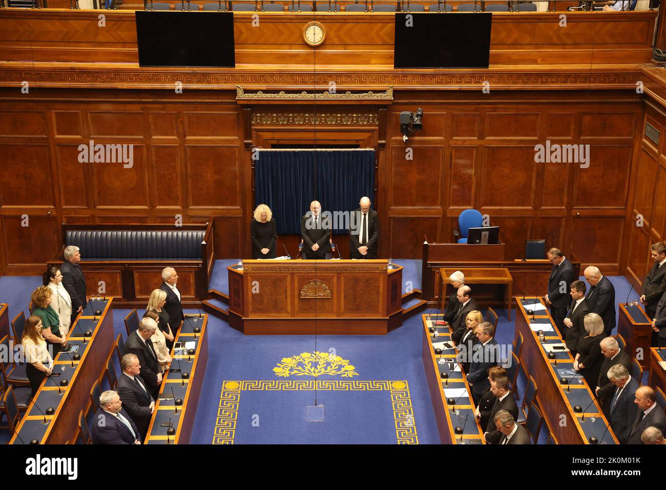 Members and staff of the Northern Ireland Assembly stand during a ...