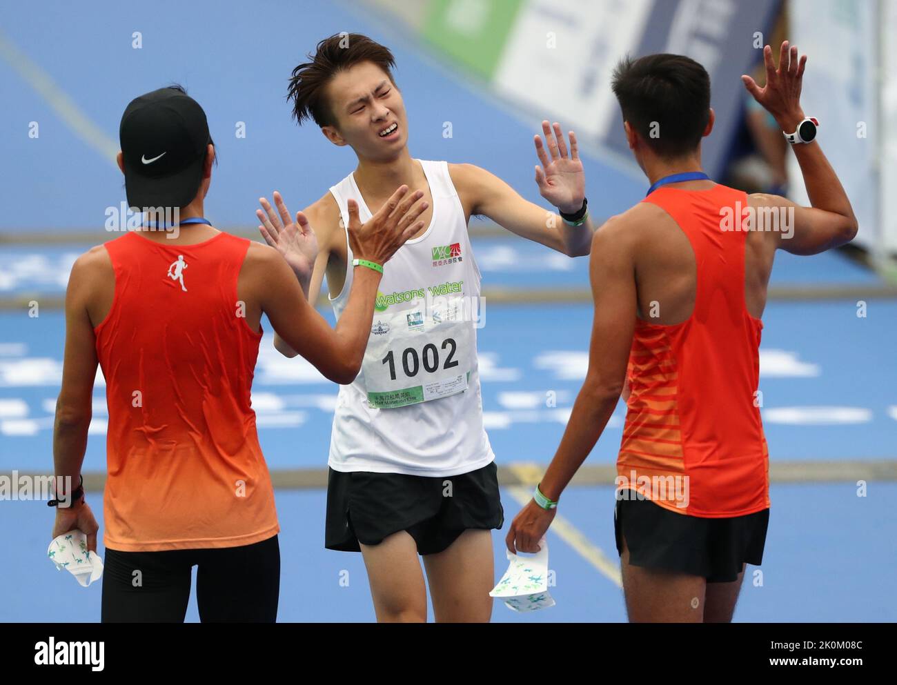 MenHH half marathon 2nd runner-up Leung Tak-yeung (centre) gives high ...