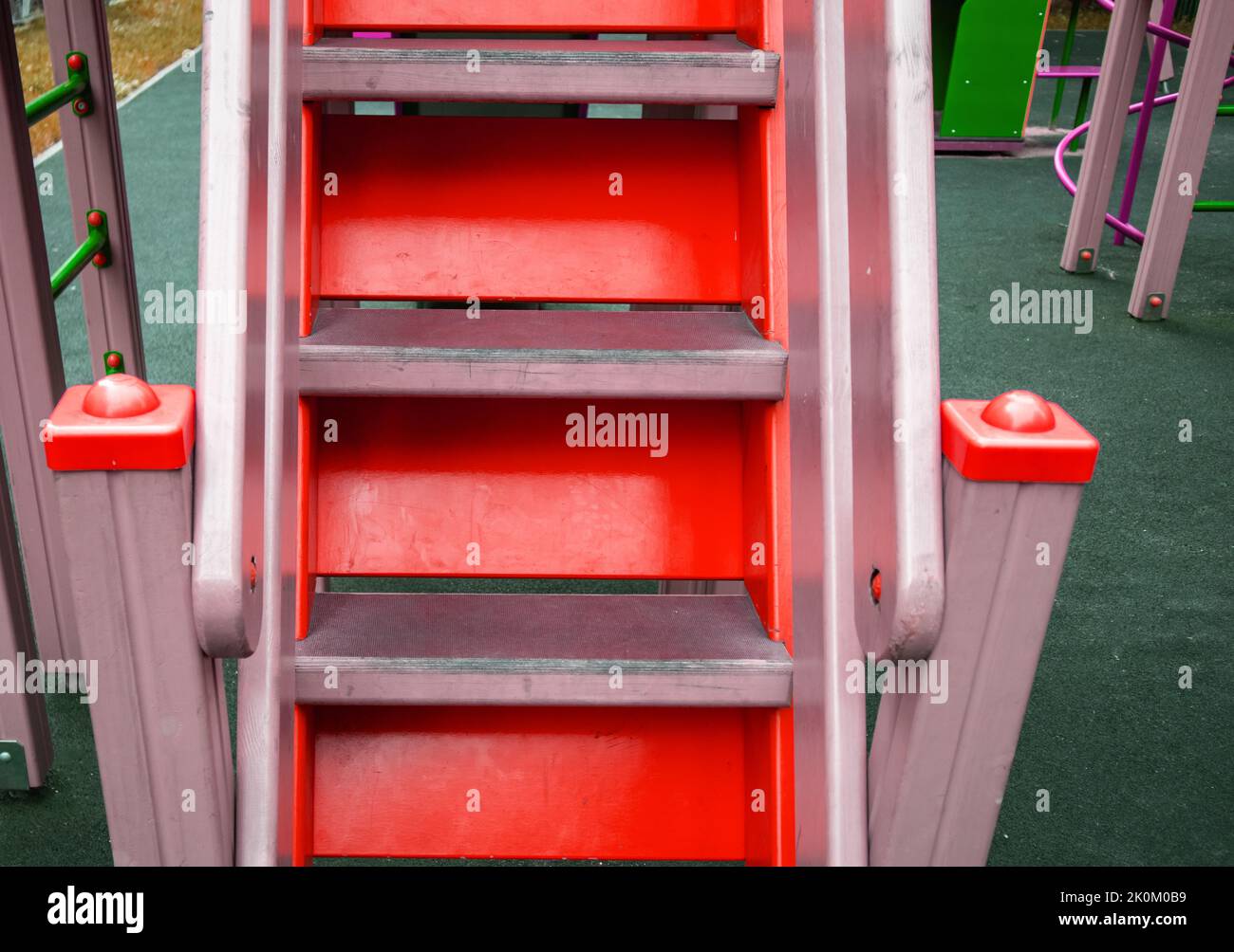 Close-up of wooden steps on an empty red staircase in an outdoor ...