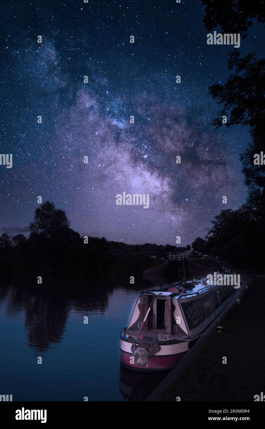 Fantasy night nscene on a canal with a moored barge Stock Photo - Alamy
