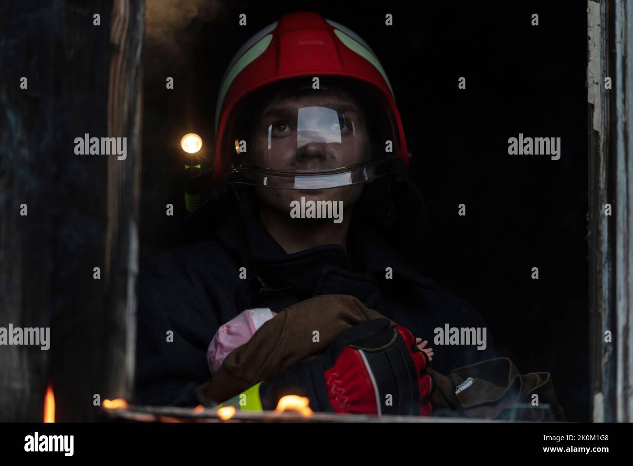 Firefighter hero carrying baby girl out from burning building area from ...