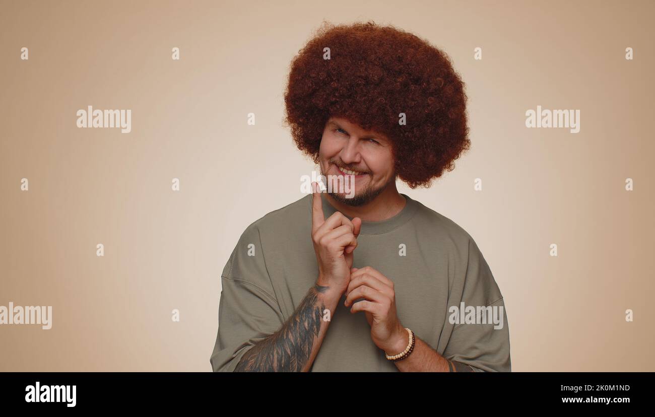 Sneaky cunning man with tricky face gesticulating and scheming evil ...