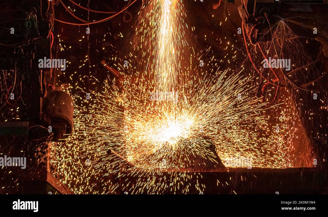 The fire sparks when casting an ingot Stock Photo - Alamy