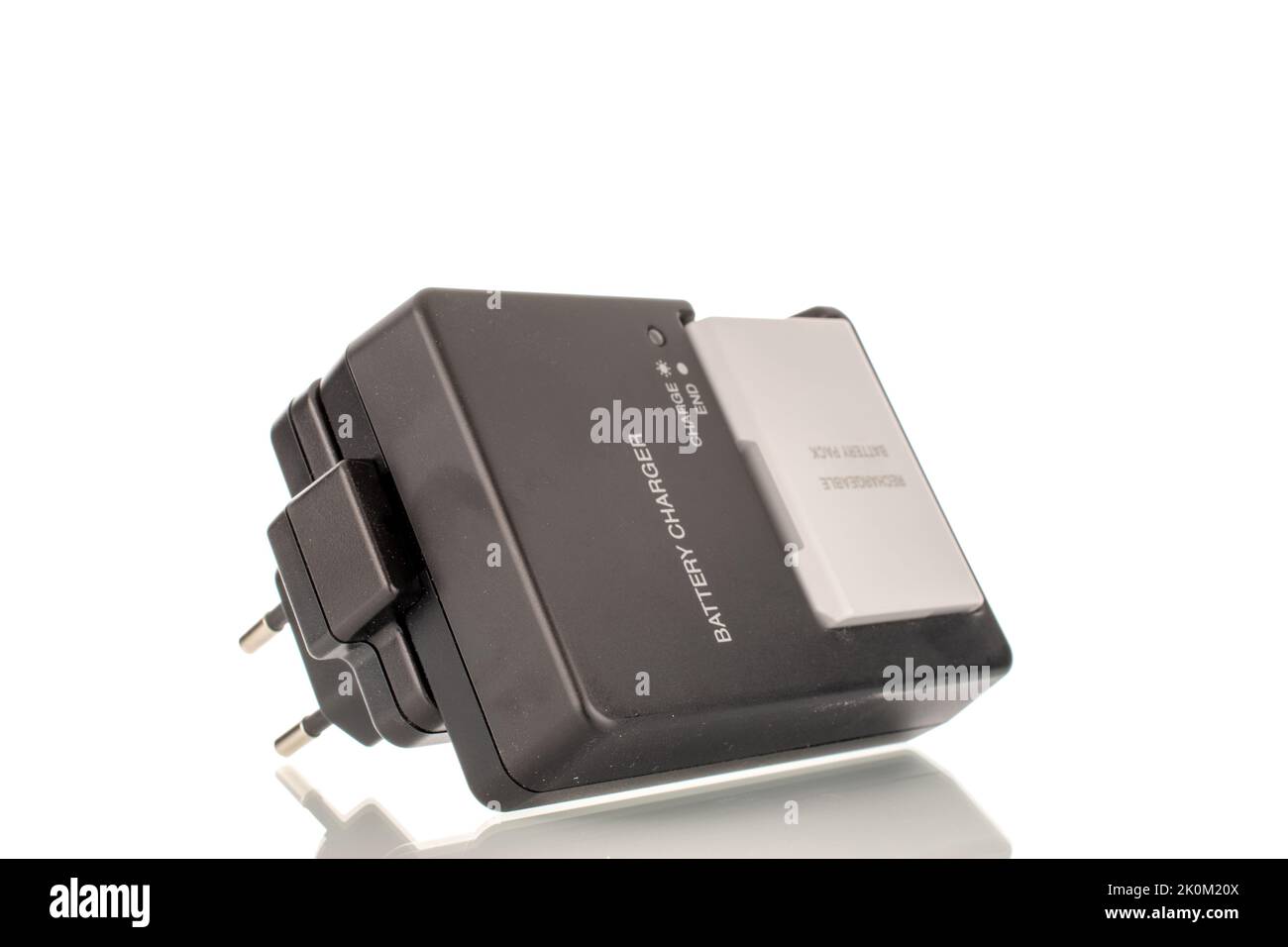One charger for a camera with an inserted battery, close-up, isolated ...