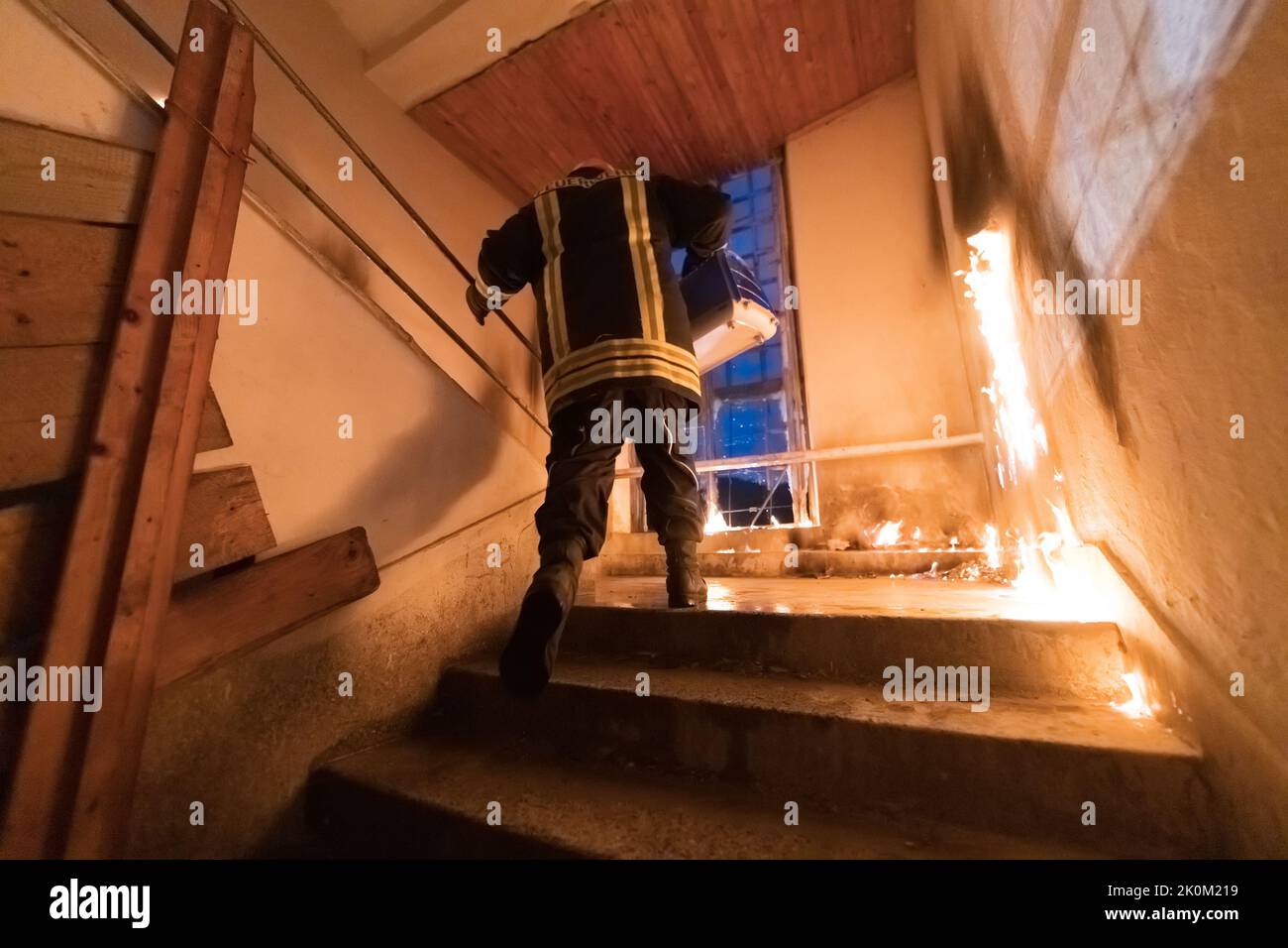 Firefighter hero carrying cat pet animal in carrying bag box out from ...