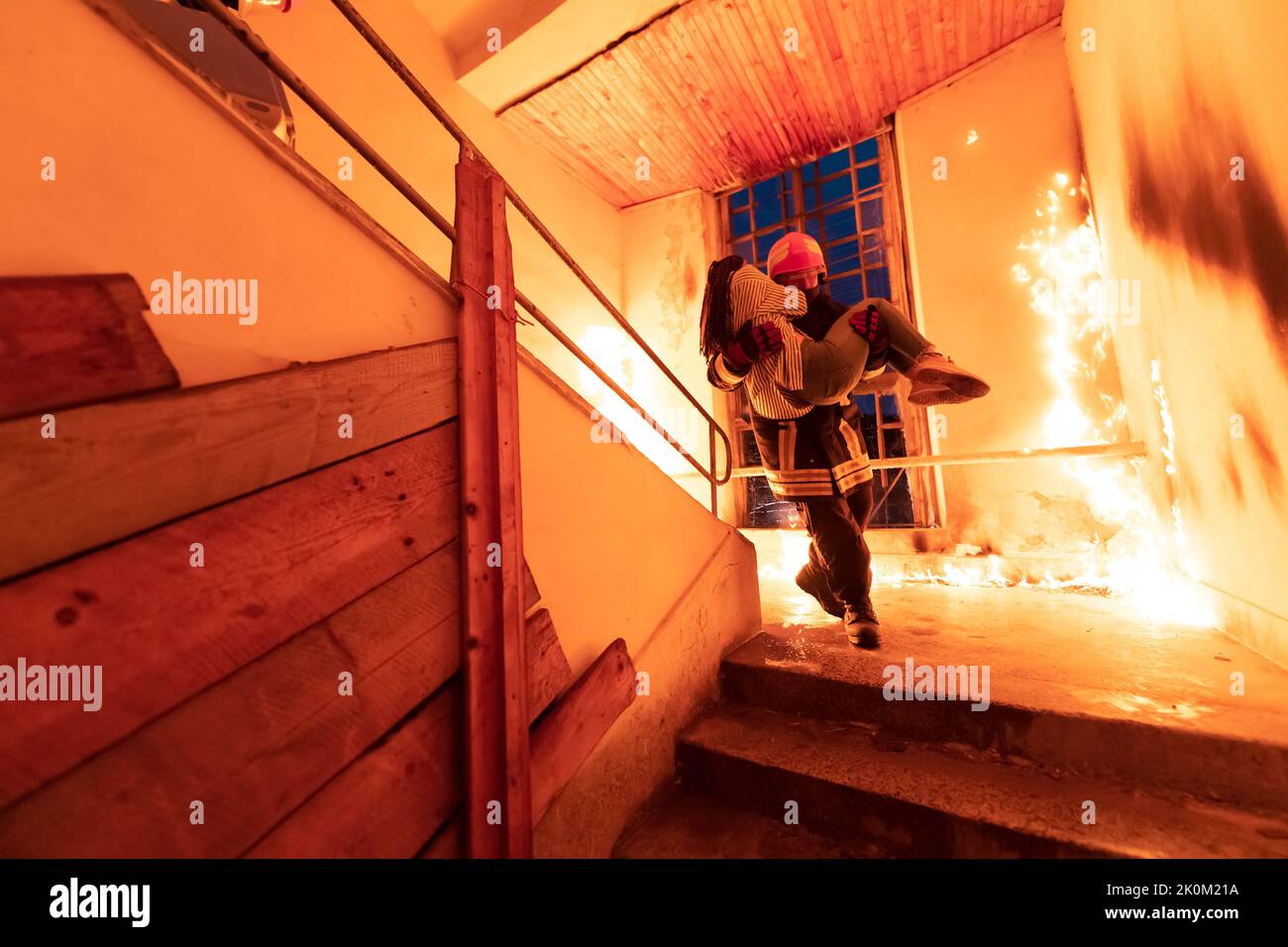 Brave Fireman Descends Stairs of a Burning Building and Holds Saved ...