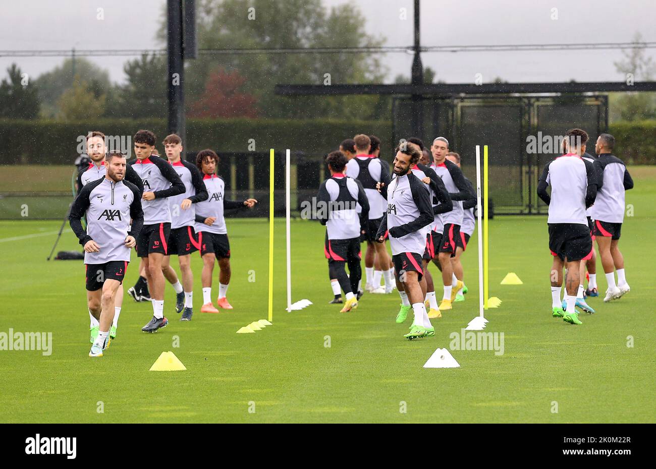 Liverpool's Mohamed Salah (right), James Milner (left) and team-mates ...
